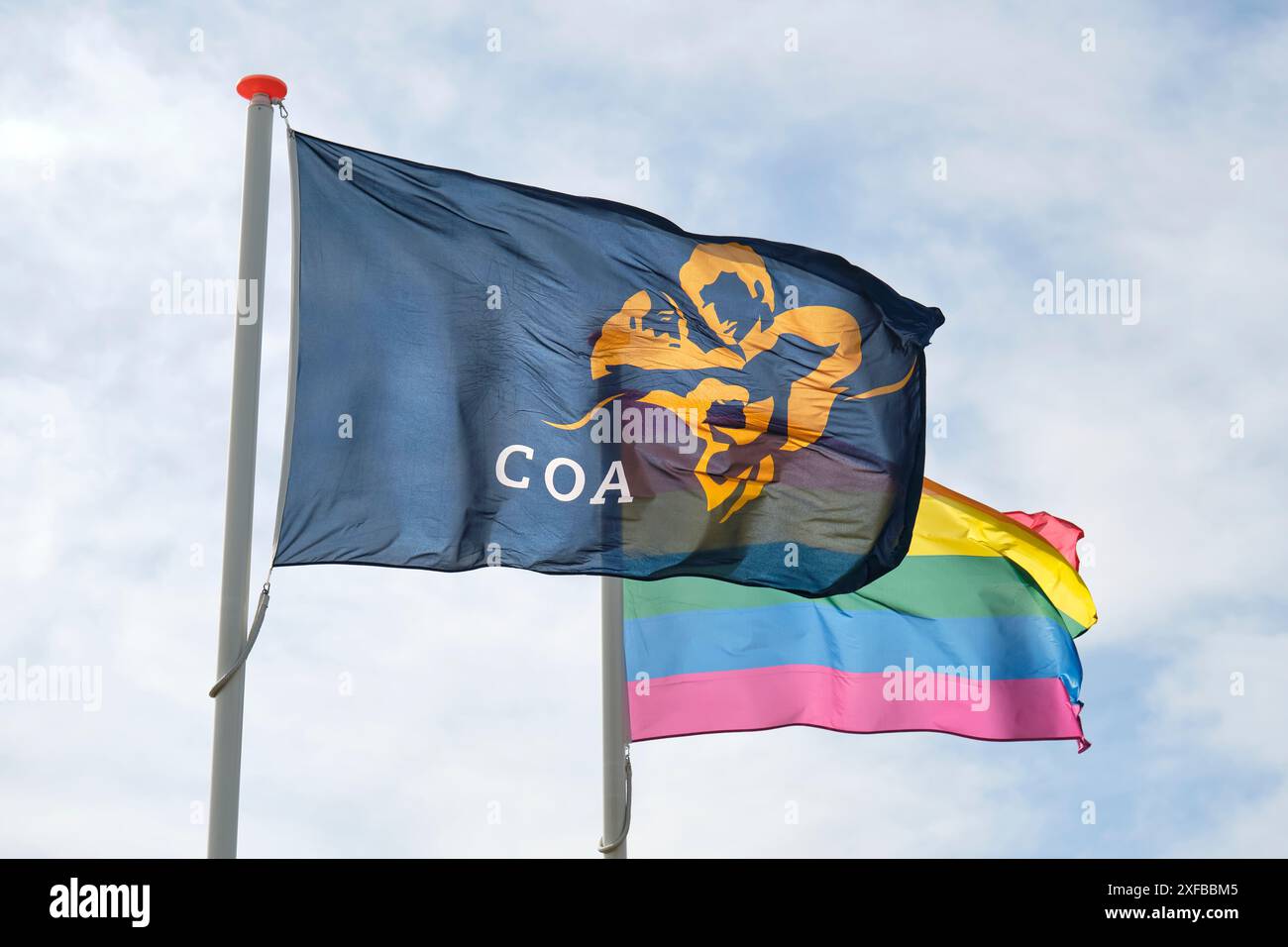 Flag of the COA and a rainbow flag at the entrance of a temporary ...