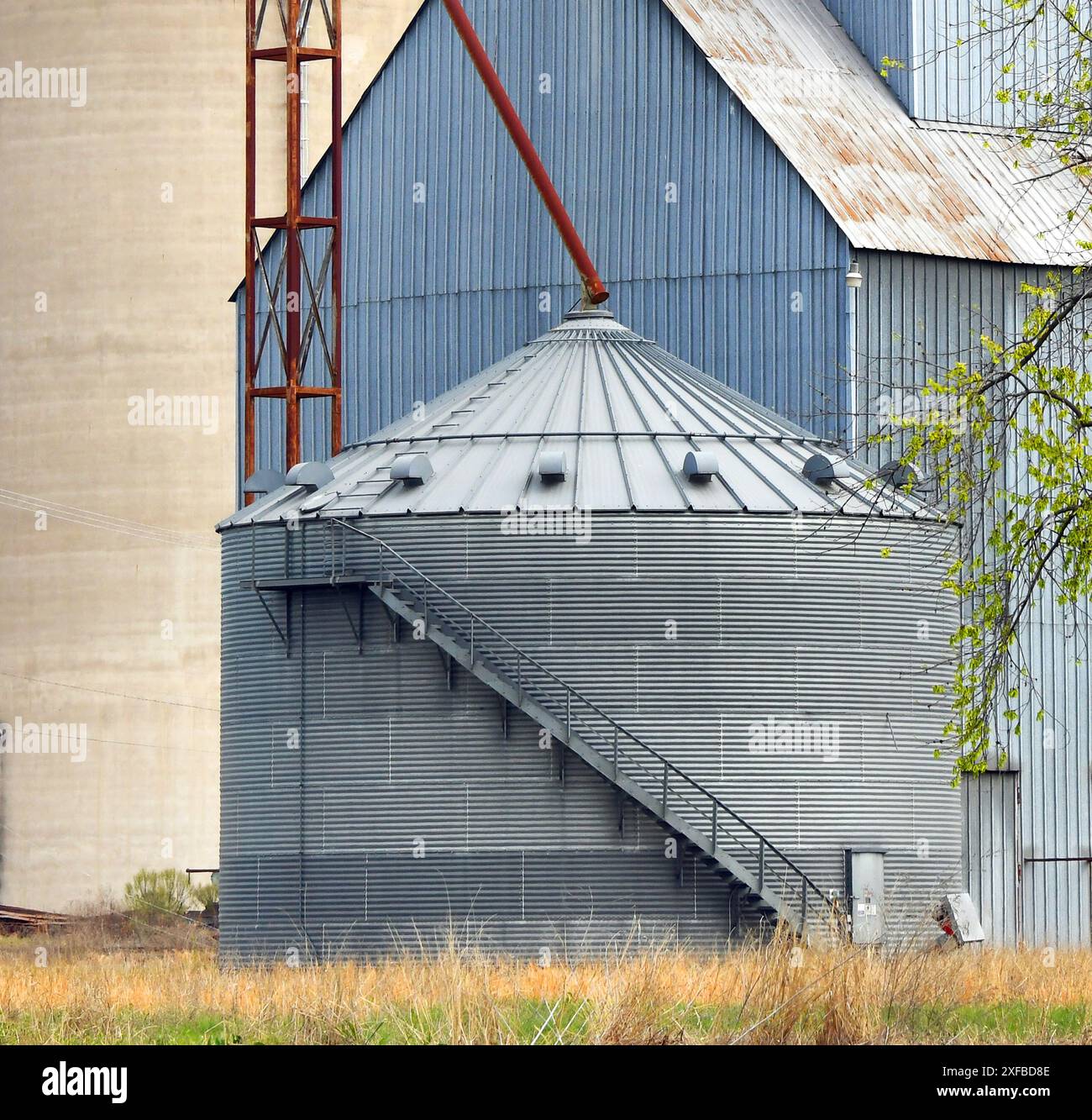 Industrial image shows round storage tank. Stair climb side of tank ...
