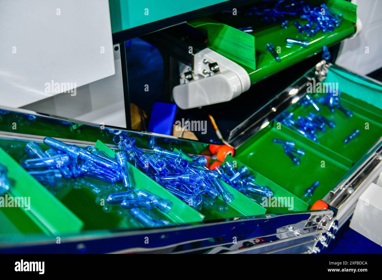 Blue Plastic bottles in production line at manufacturing PET perform ...