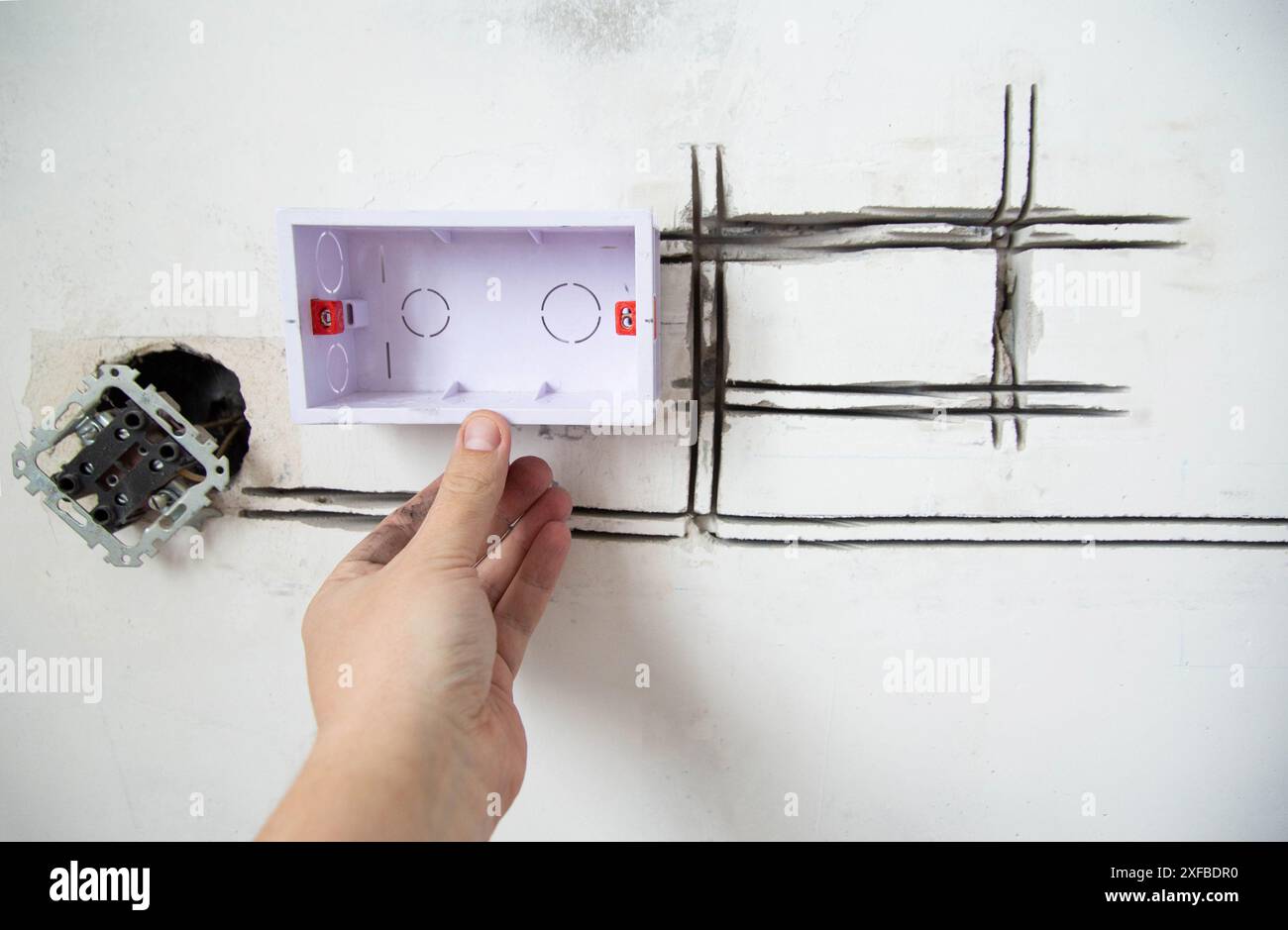 Grooves in a concrete wall for installing new socket boxes for sockets ...