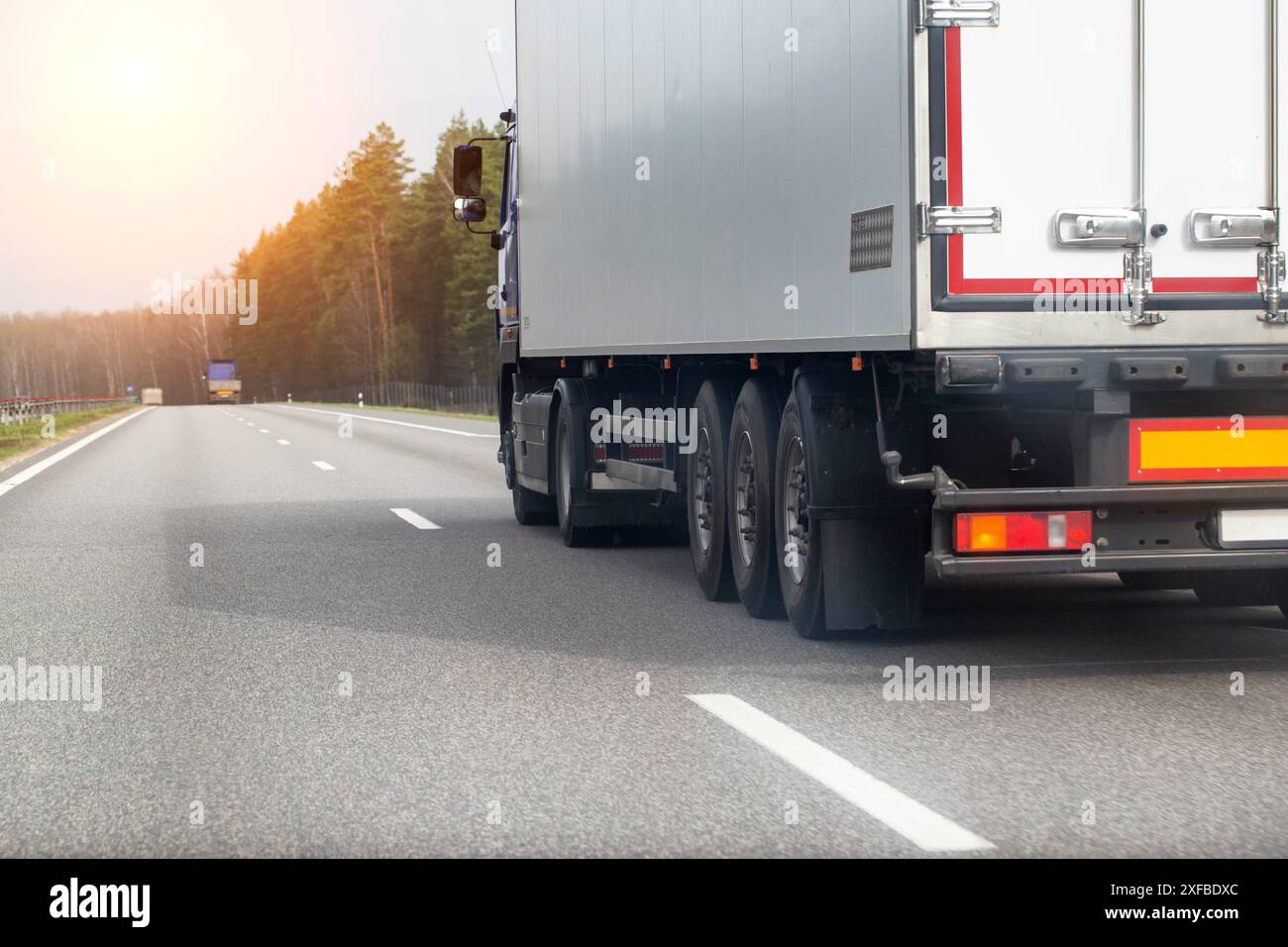 A new truck with a white isothermal semi-trailer transports a load of ...