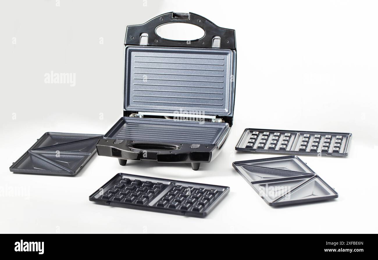 Sandwich maker with baking dishes on a white background, isolate, close ...