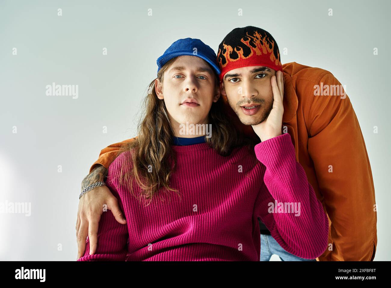 two men sitting closely, engaged in conversation and sharing a moment ...