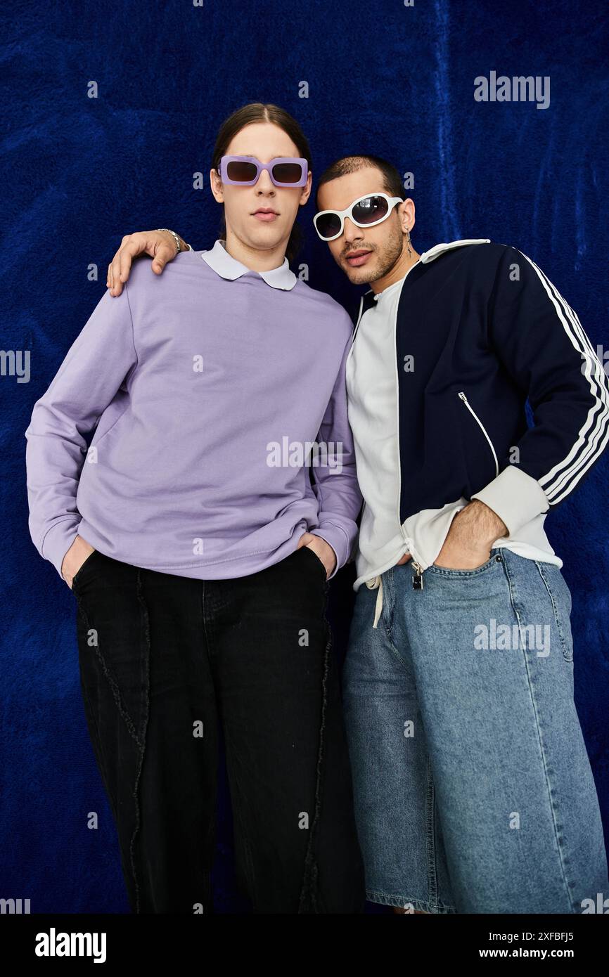 Two men standing together, looking chic in sunglasses Stock Photo - Alamy