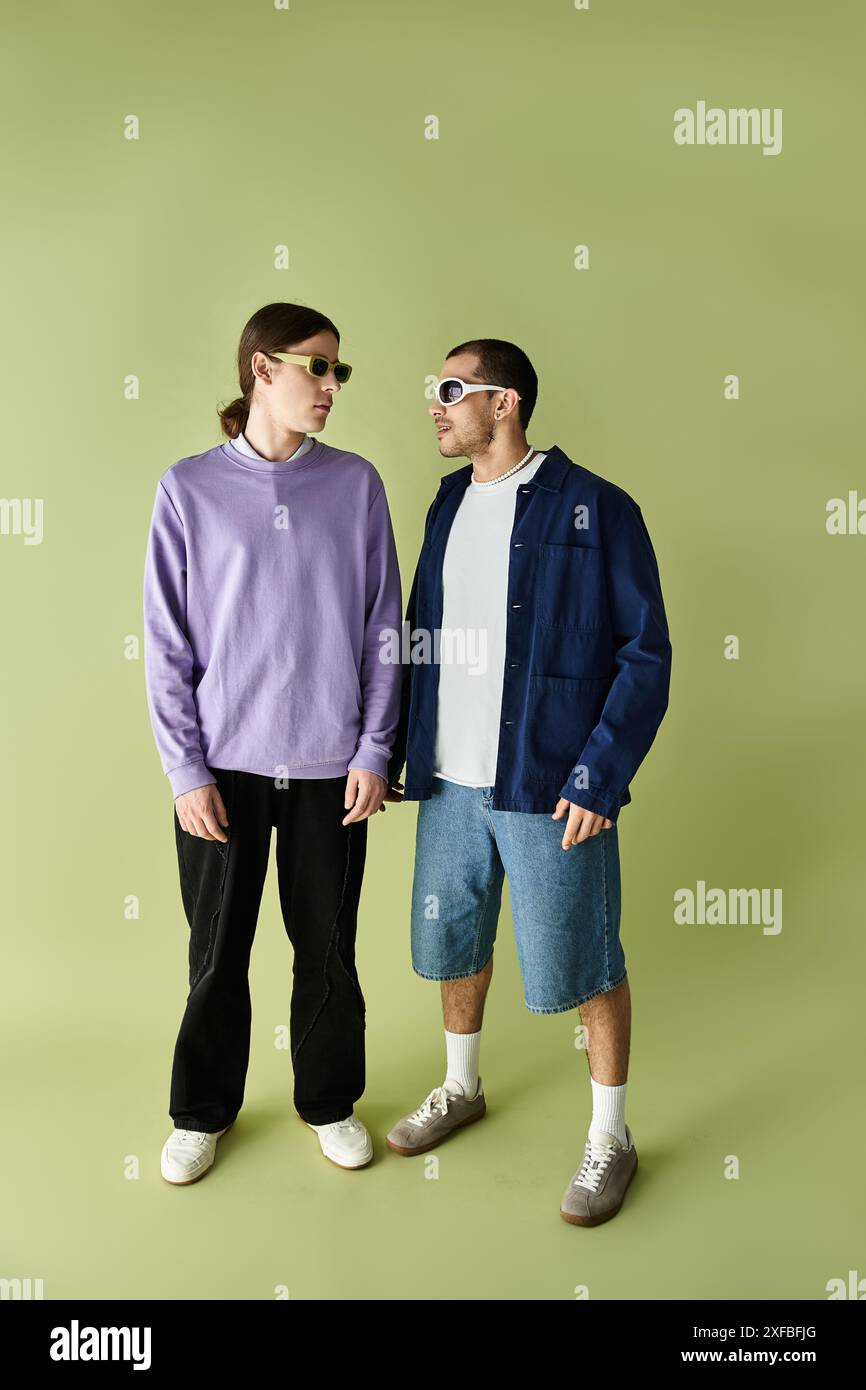 Two men, attractive and poised, stand peacefully before a vibrant ...