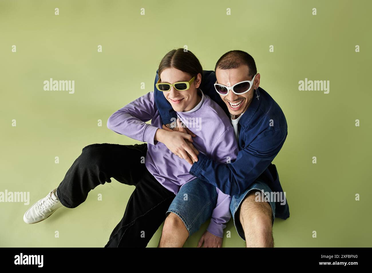 two men seated intimately intertwined, displaying unity and harmony ...