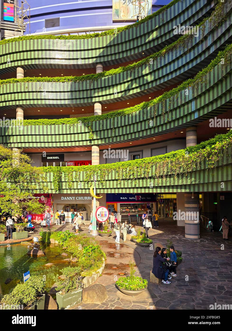 The parapet walls are lined with tropical plants in this shopping mall ...