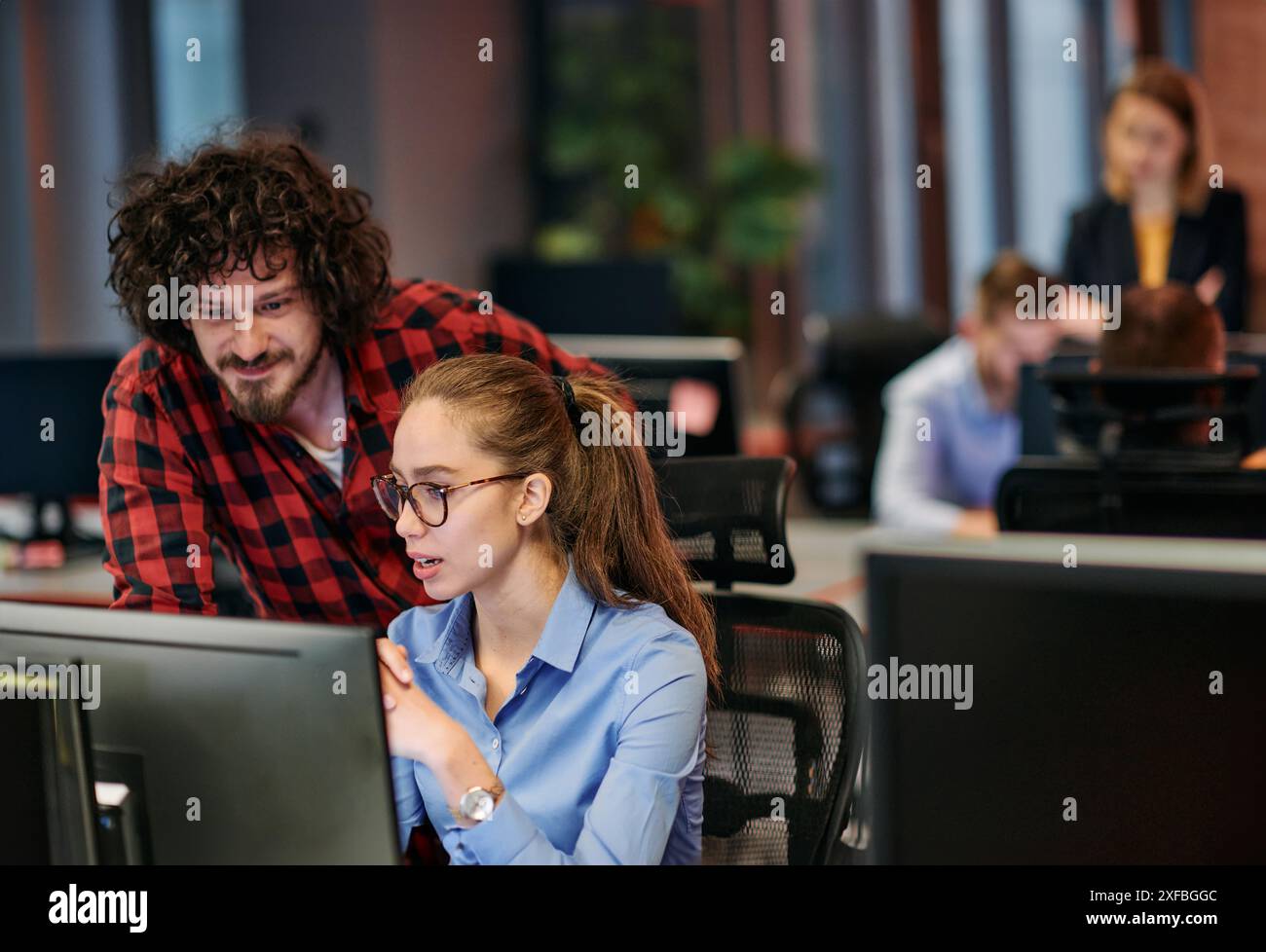 Business colleagues, a man and a woman, engage in discussing business ...