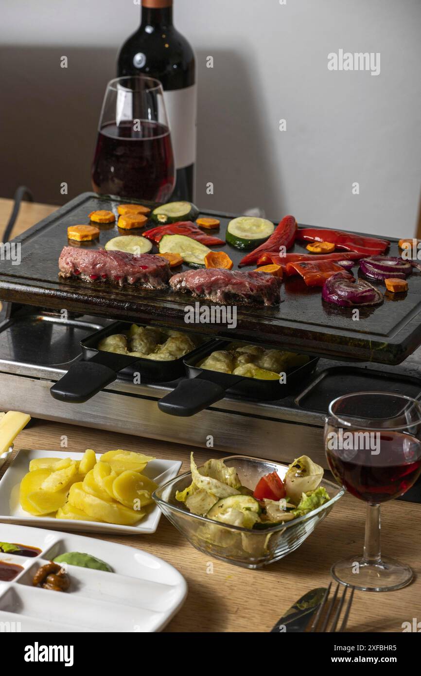 Swiss raclette with meat and vegetables Stock Photo - Alamy
