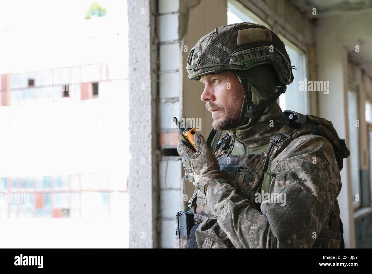 Military mission. Soldier in uniform with radio transmitter inside ...
