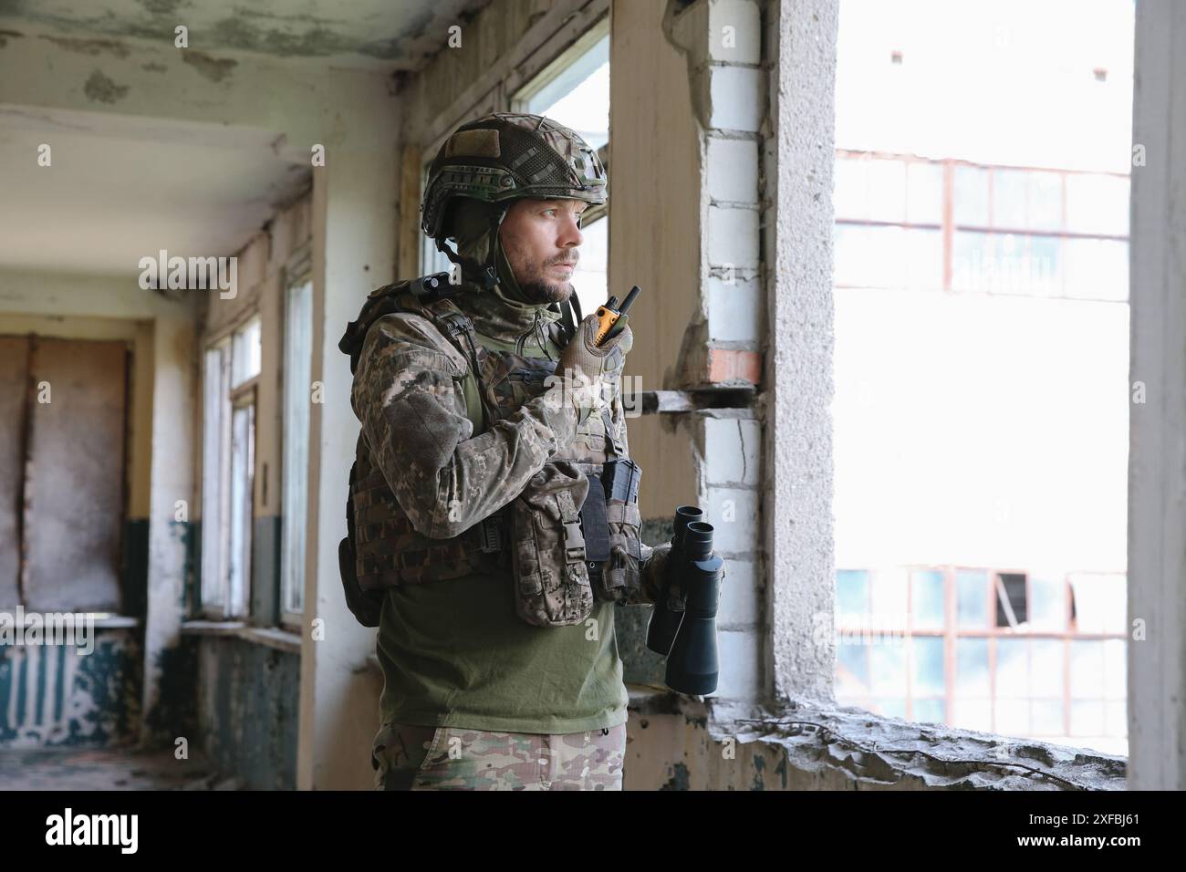 Military mission. Soldier in uniform with radio transmitter inside ...