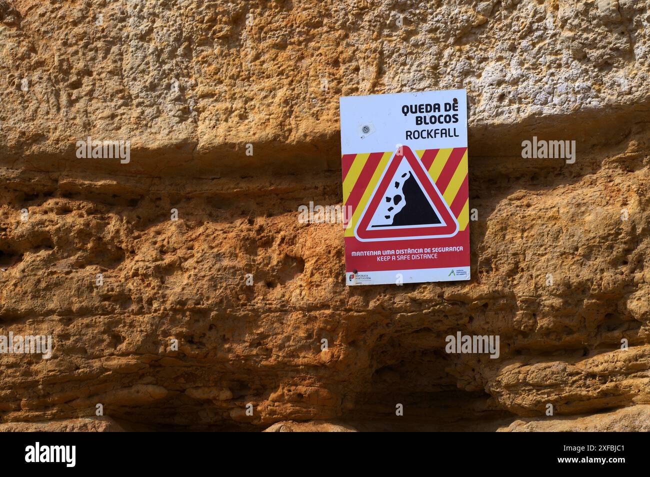 Rockfall, warning sign, danger of falling rocks, unstable cliff, beach ...