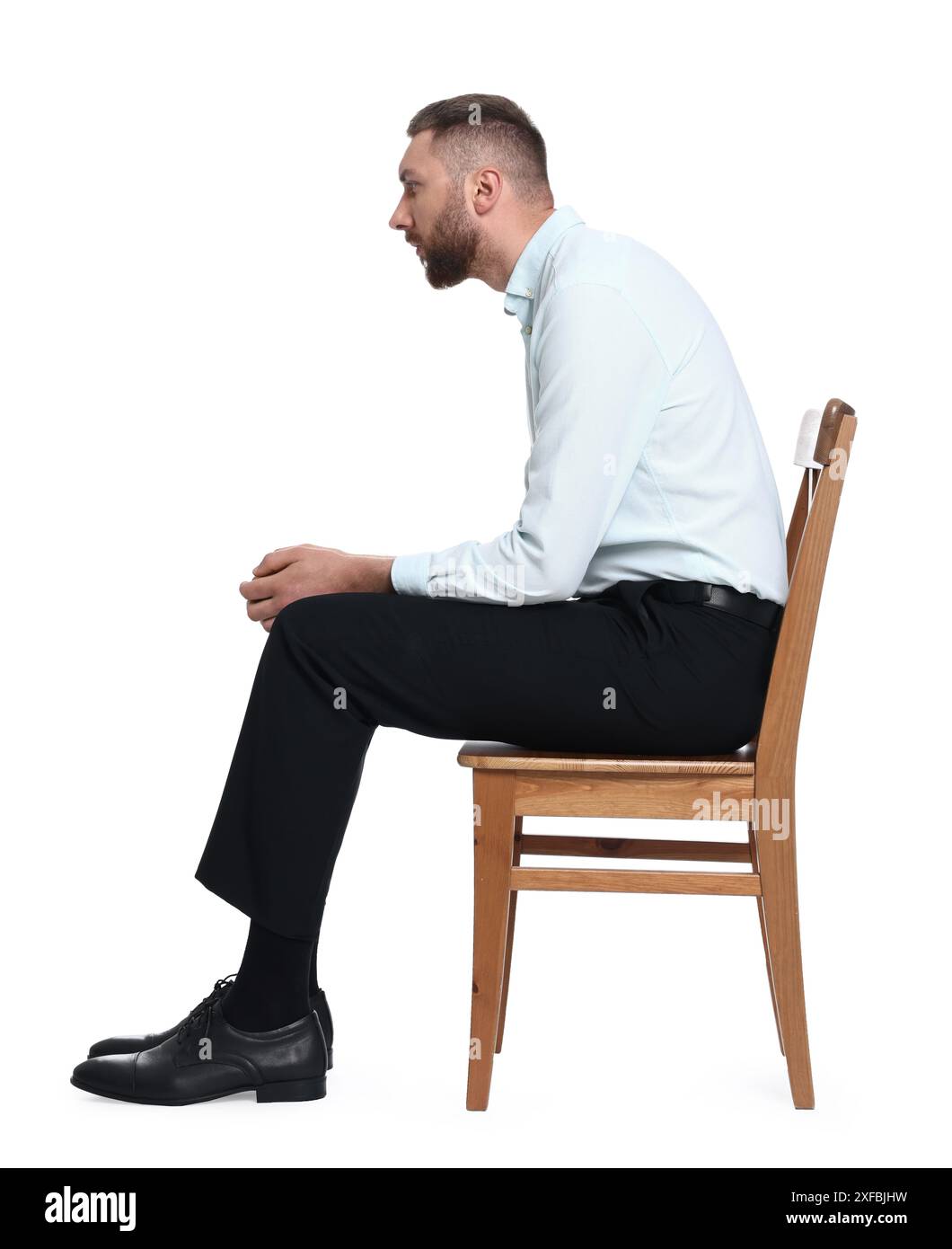 Man with poor posture sitting on chair against white background Stock ...