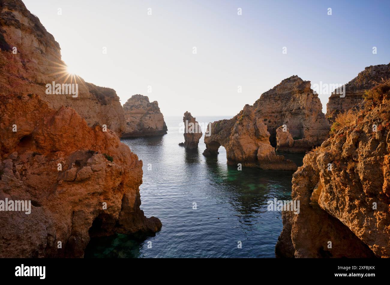 Coloured cliffs and sunrise, rocks in the sea, Ponta da Piedade, Lagos ...