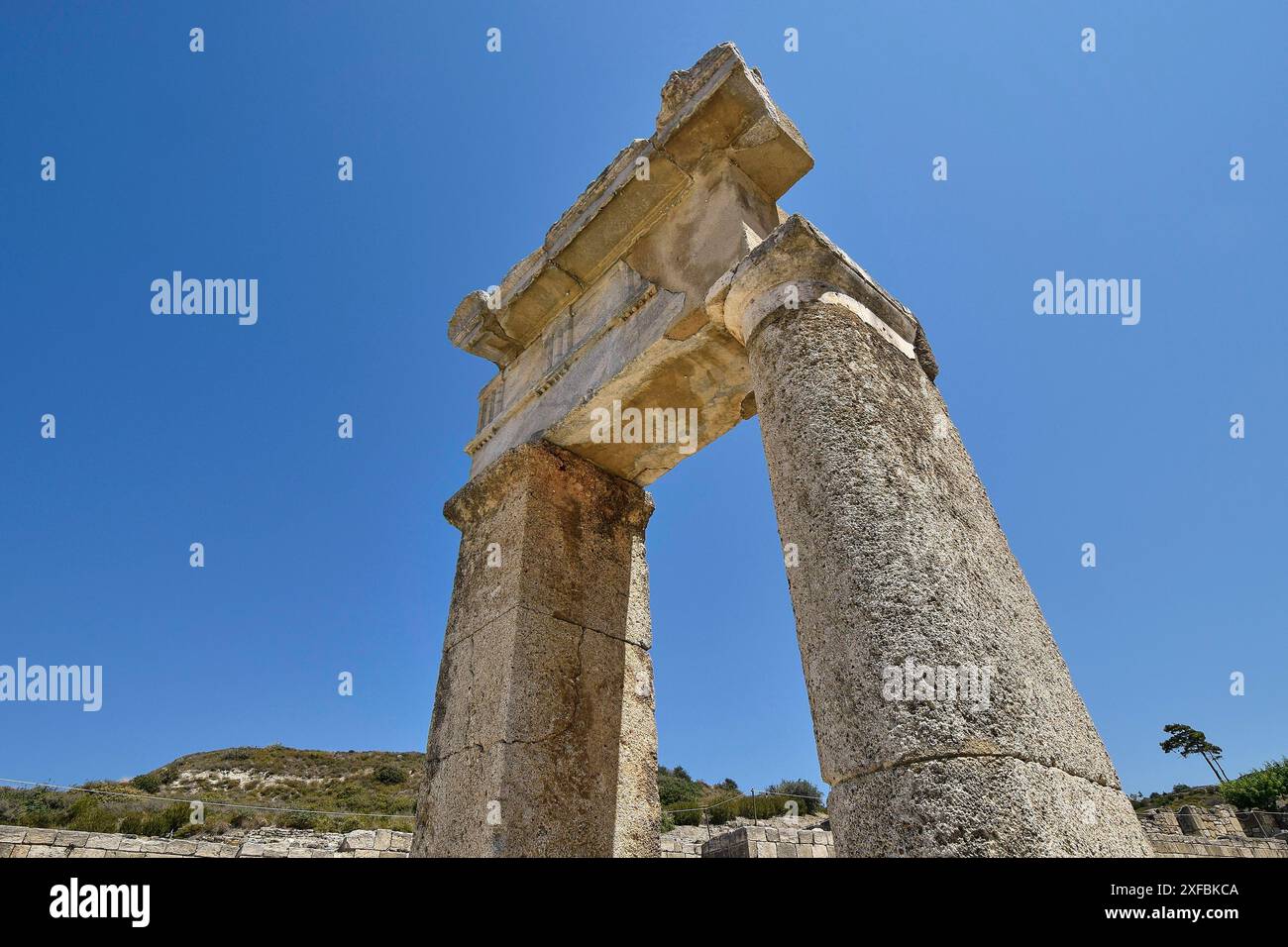 Stone ancient column rises under a clear blue sky, Kamiros ...