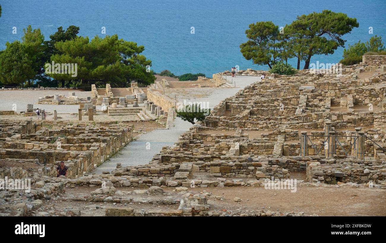 Ancient ruins with sea view, surrounded by vegetation and scattered ...