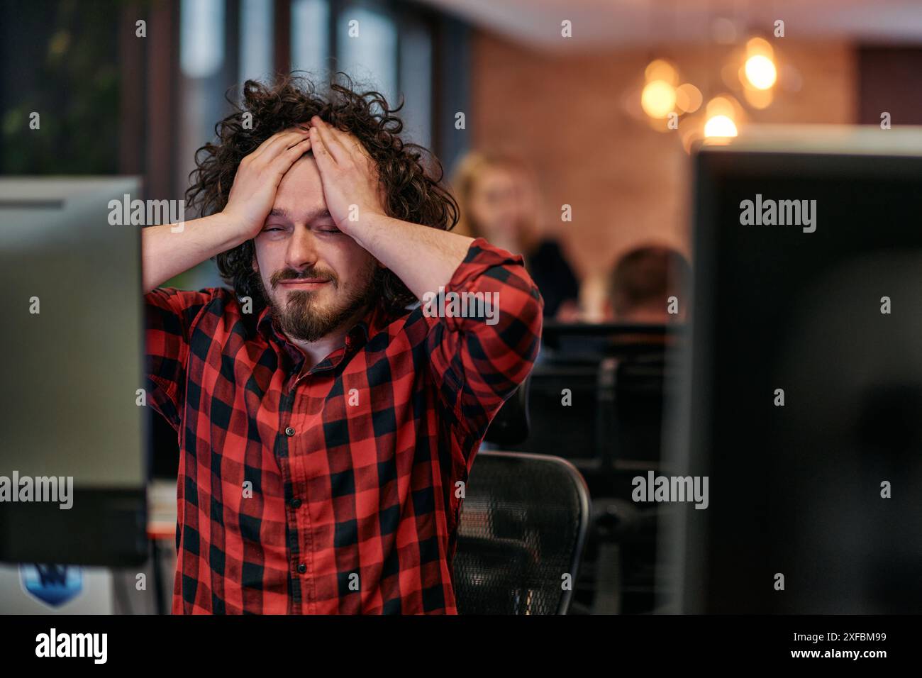 Disappointed Programmer with Messy Hair Looking at Computer Monitor in ...