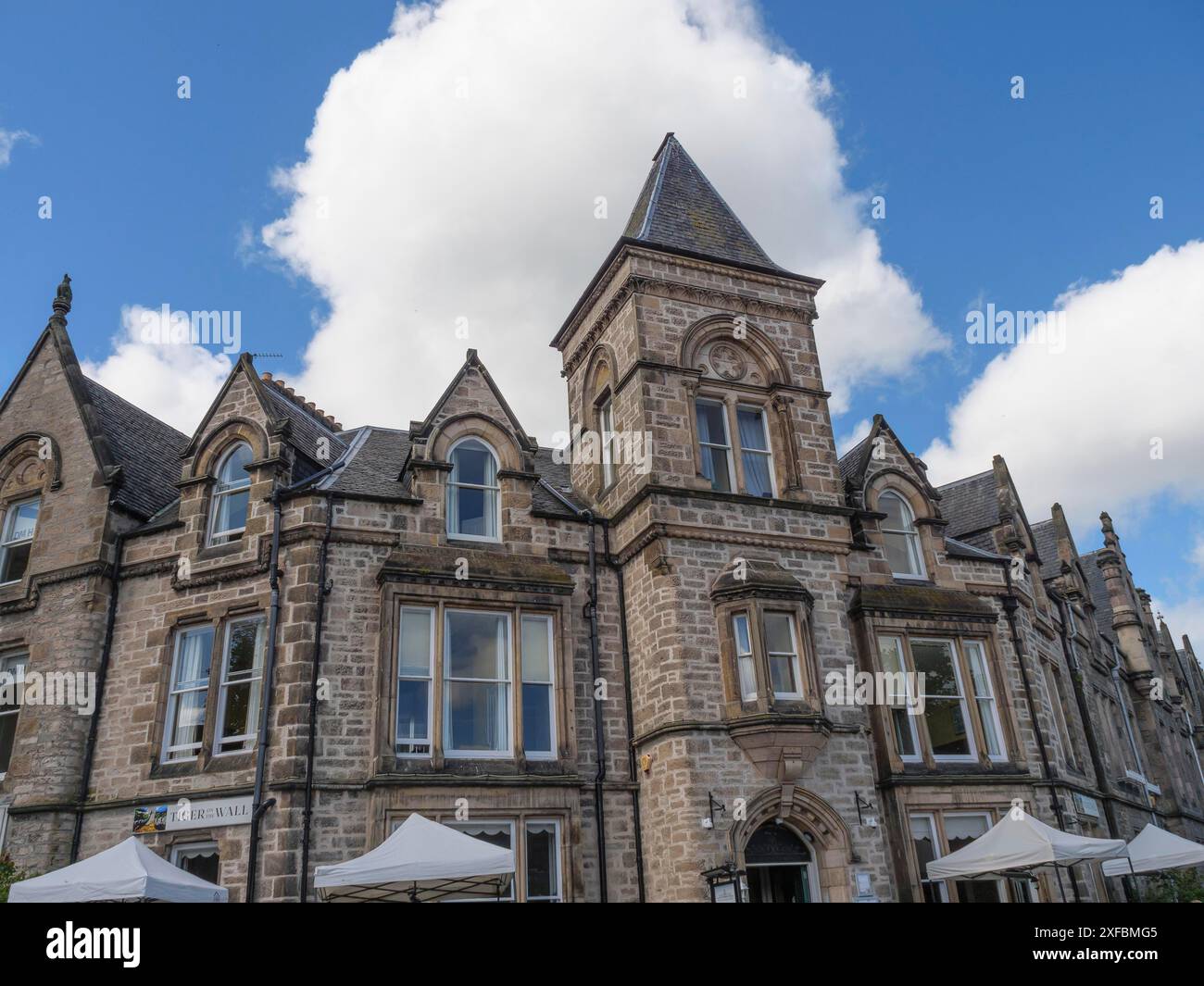 An imposing historic building with several towers and windows under a ...
