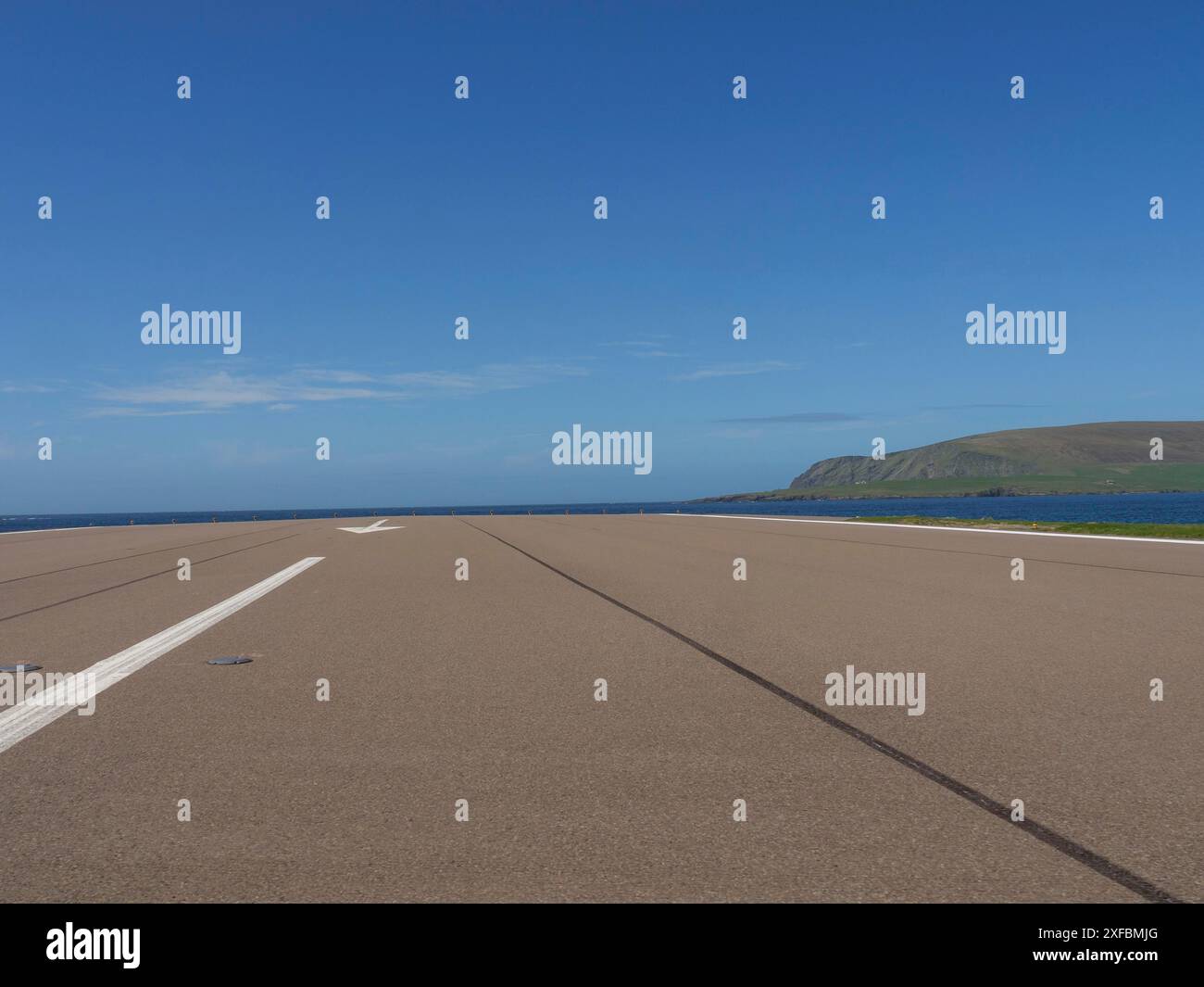 Long runway with a view of the horizon and clear sky. The surroundings ...