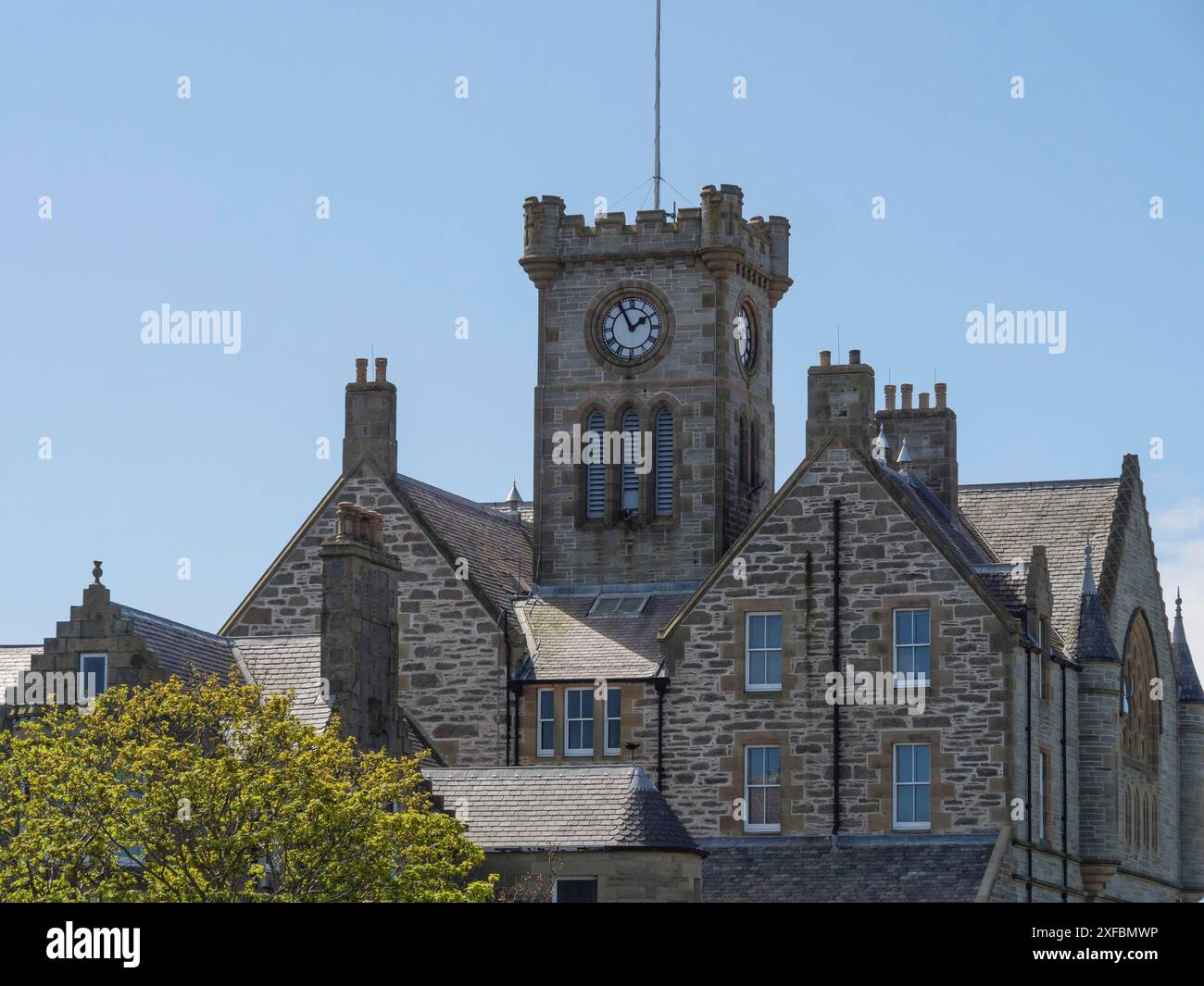 Historic church building with clock tower, stone walls and classical ...