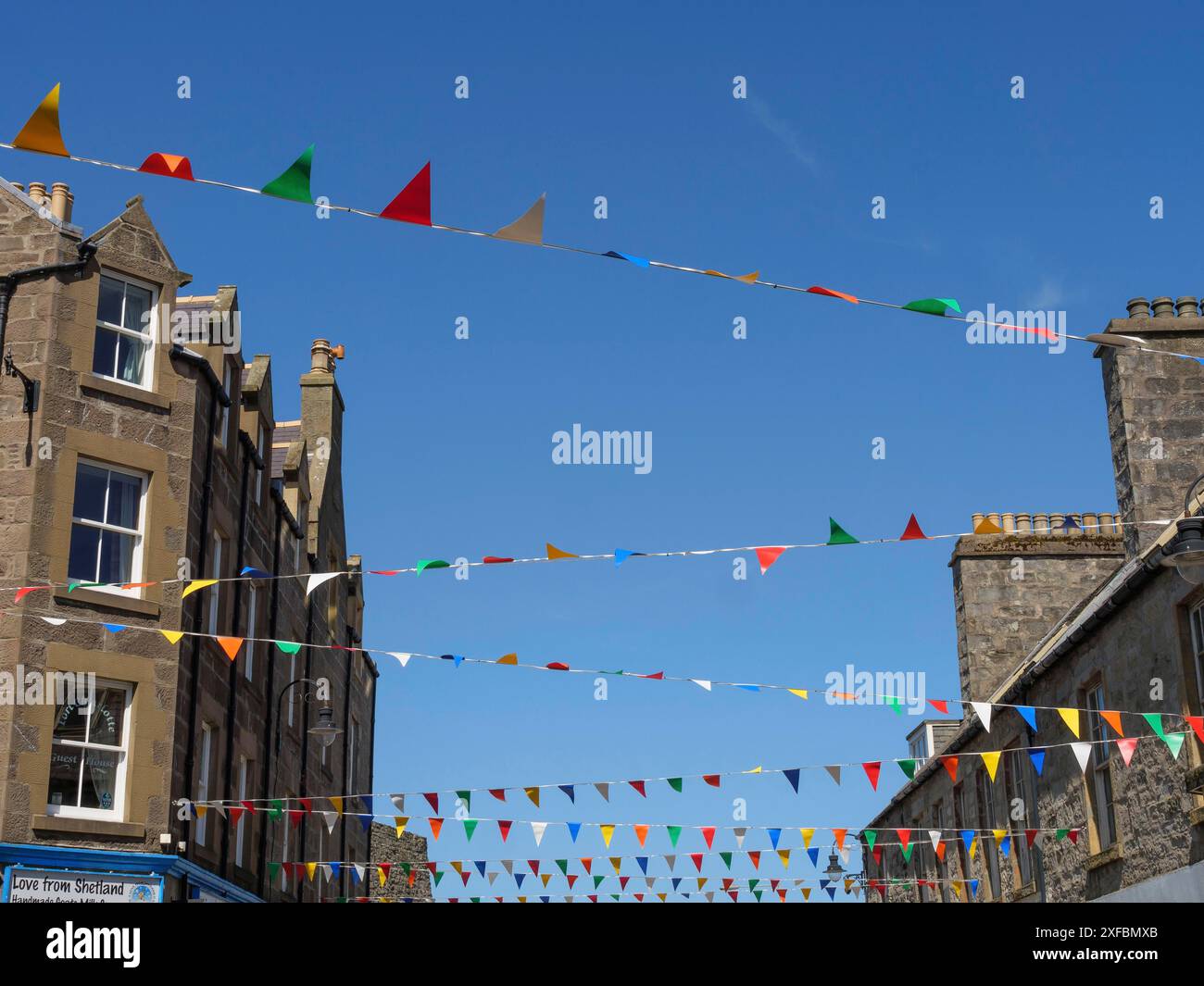 Town view with colourful pennants and historic buildings under a clear ...