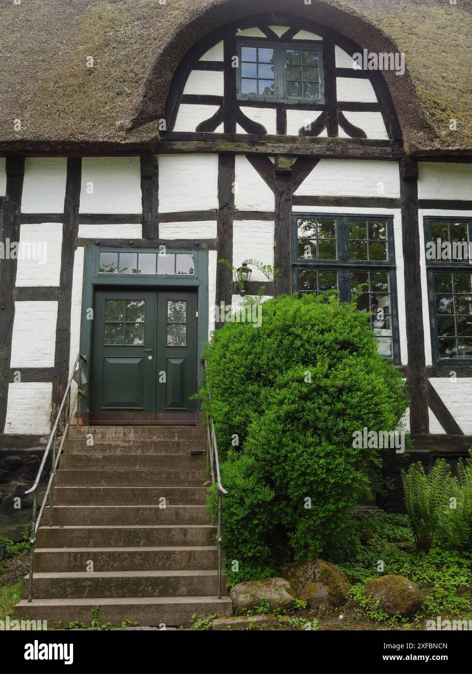 Entrance of a traditional half-timbered house with stairs and well-kept ...