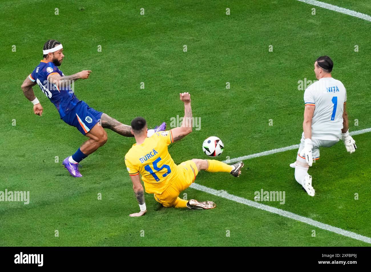 Memphis Depay of the Netherlands, left, shoots against Romania's Andrei ...