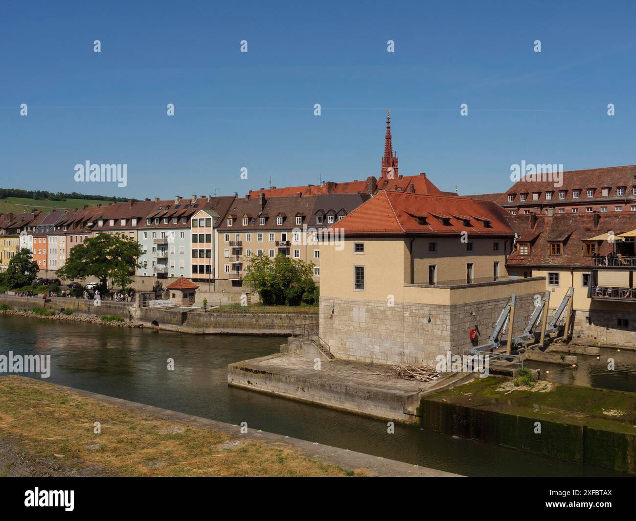 Old town building by a river under a clear blue sky, wuerzburg, bavaria ...