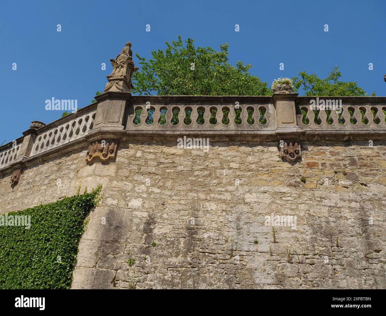 An impressive historic stone wall with decorative sculptures and ...