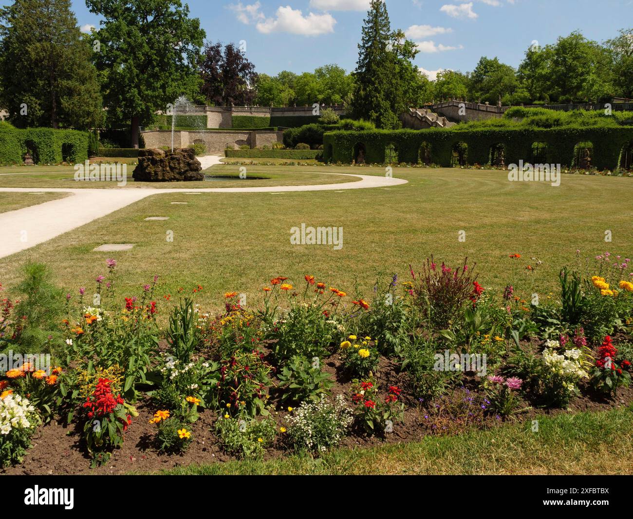 An extensive garden landscape with blooming flowers, manicured lawns ...