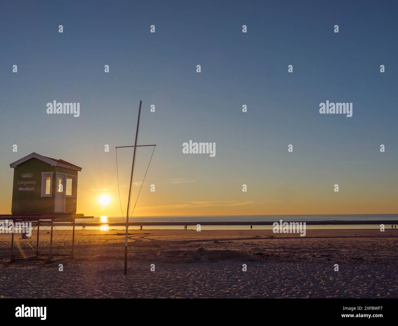 Clear sunset light over the sea and the beach with a lifeboat station ...