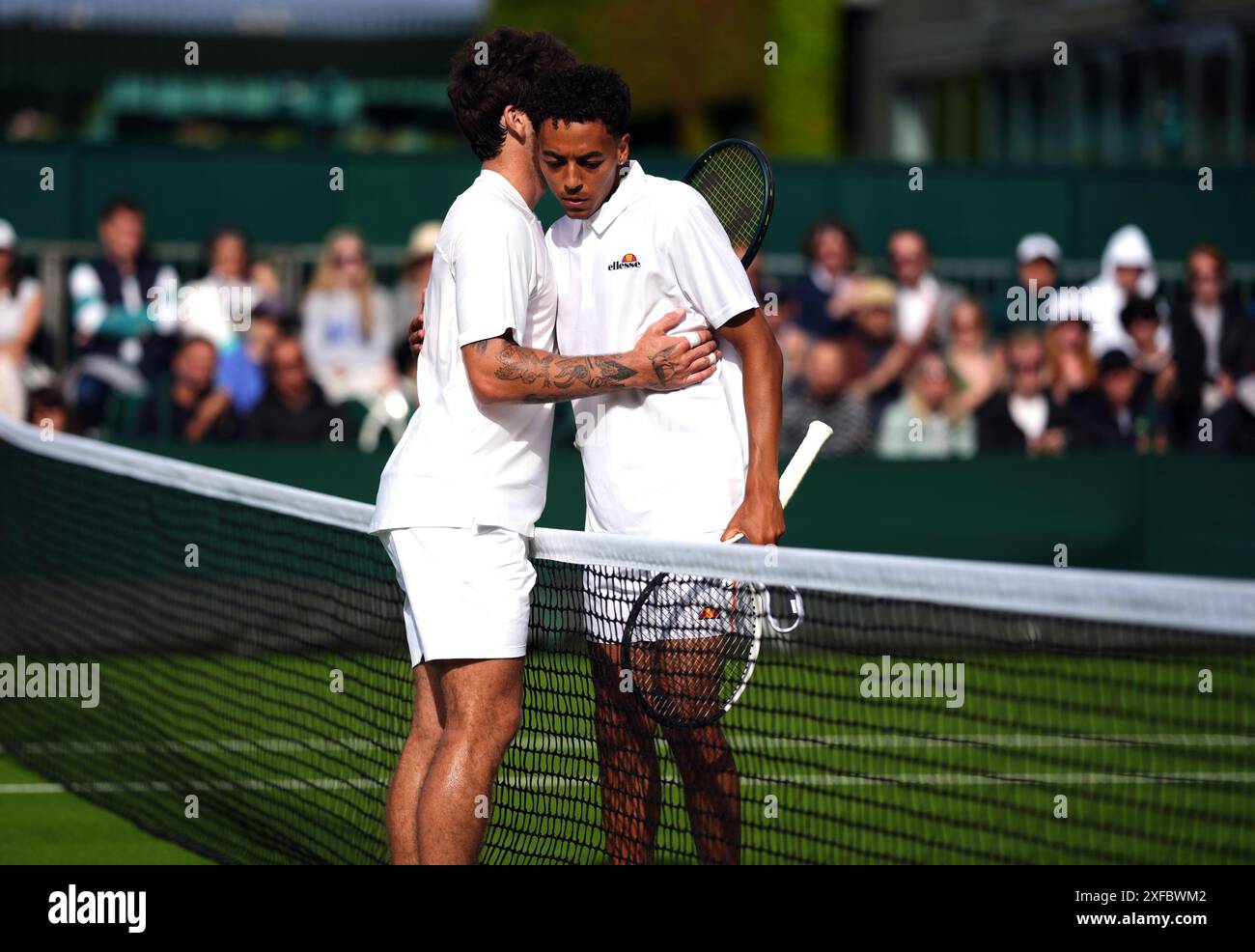 Thiago Seyboth Wild consoles Paul Jubb at the net following their match ...