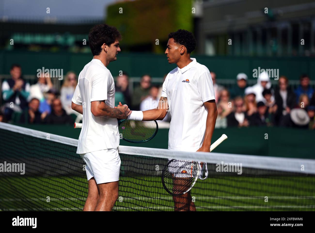 Thiago Seyboth Wild consoles Paul Jubb at the net following their match ...