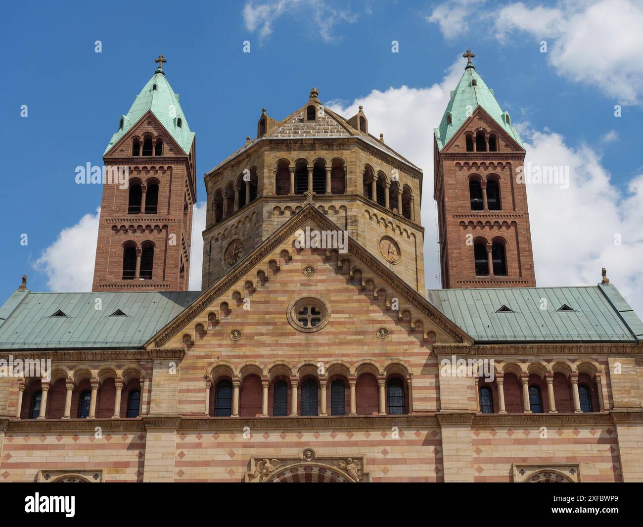 Romanesque cathedral with towers and richly textured facade under a ...