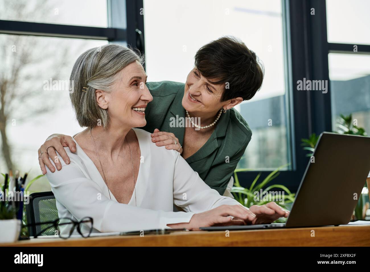 Two business professionals engage laptop hi-res stock photography and ...