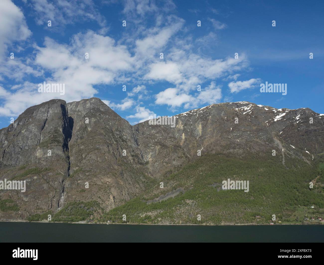 In the middle of a mountain landscape, steep, rocky walls rise up under ...