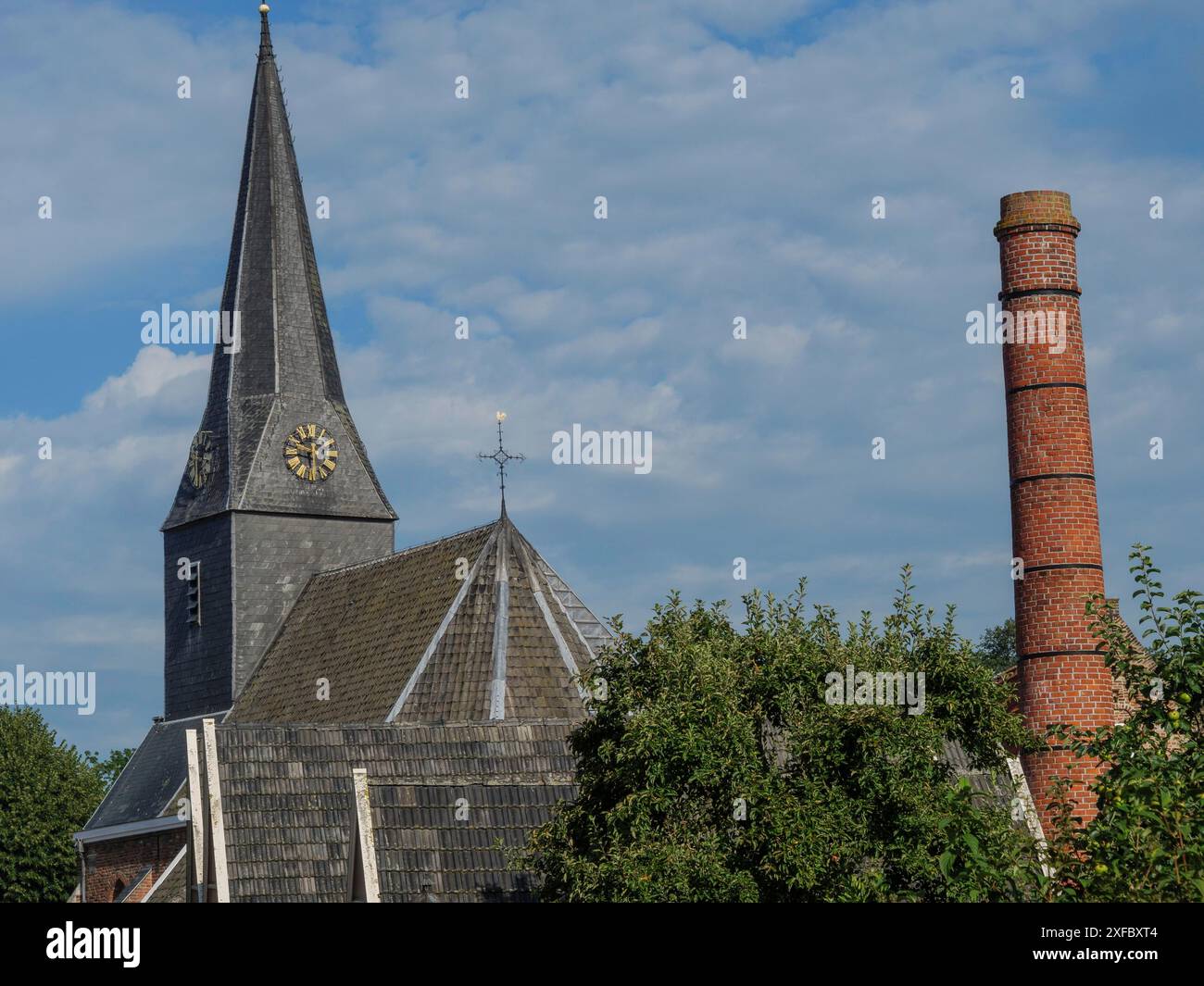 Church tower and old chimney rise above the village buildings, with ...