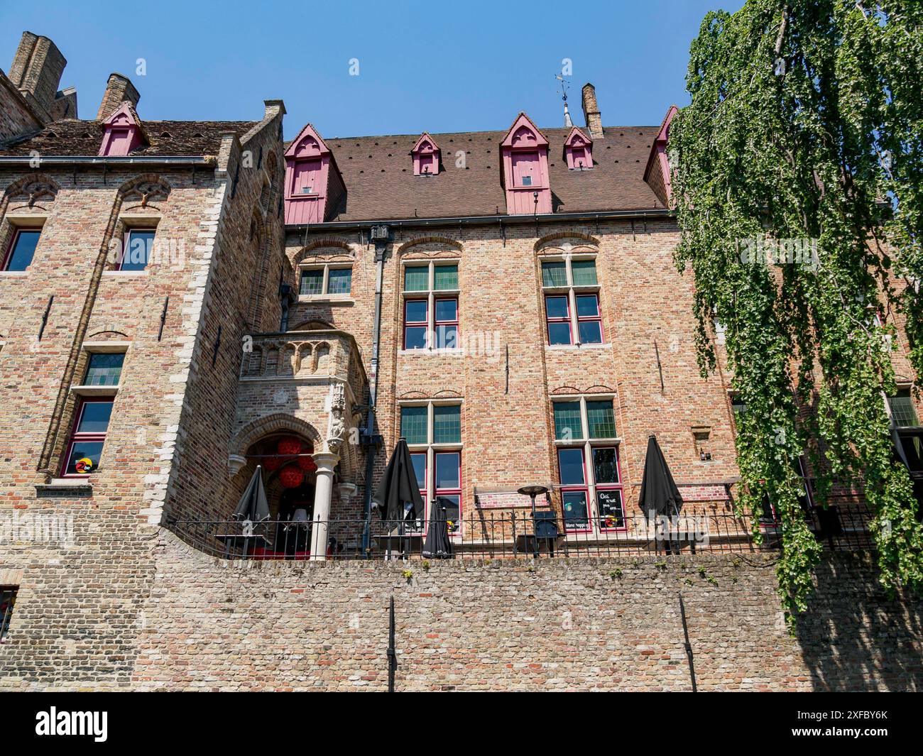 Tall brick building with decorative windows, balustrades and black ...