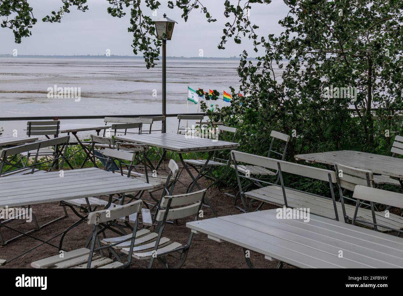 White garden furniture on a terrace with a view of the cloudy sea ...