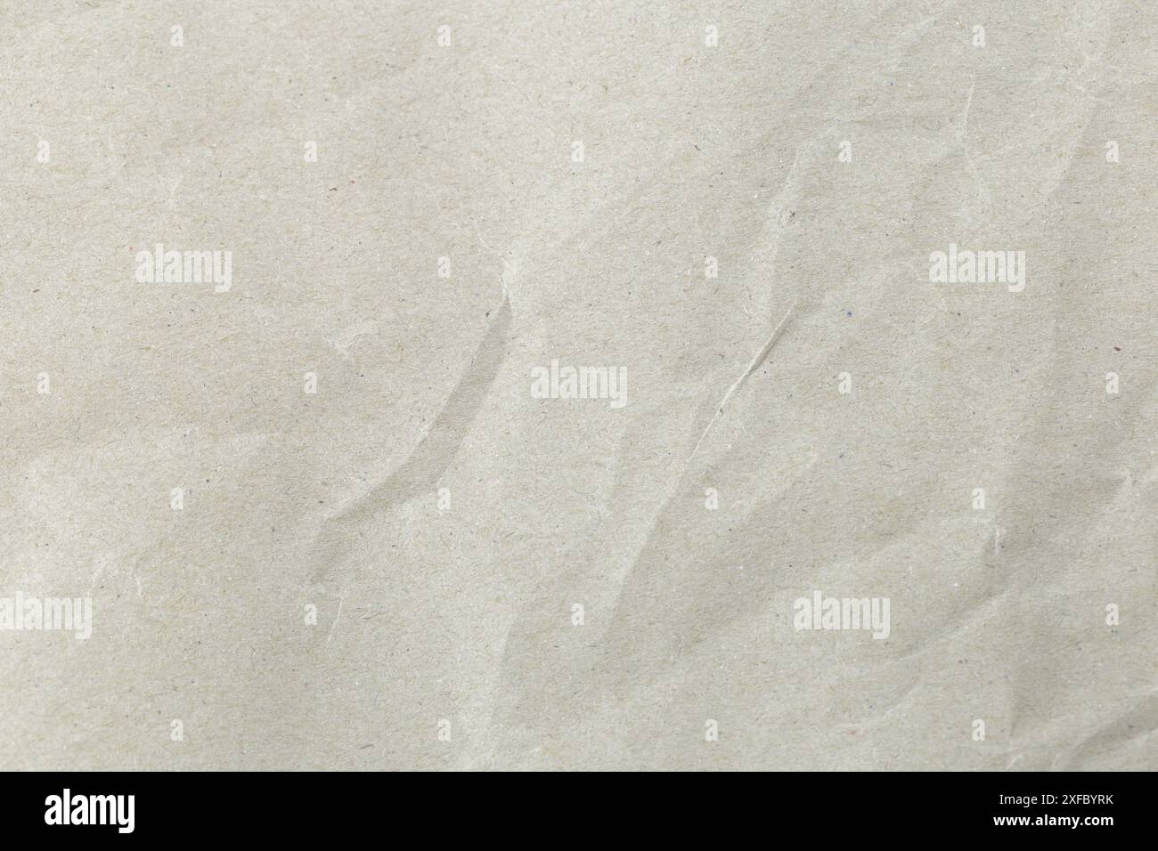 A grey paper with a grainy texture. The paper is wrinkled, giving it a ...
