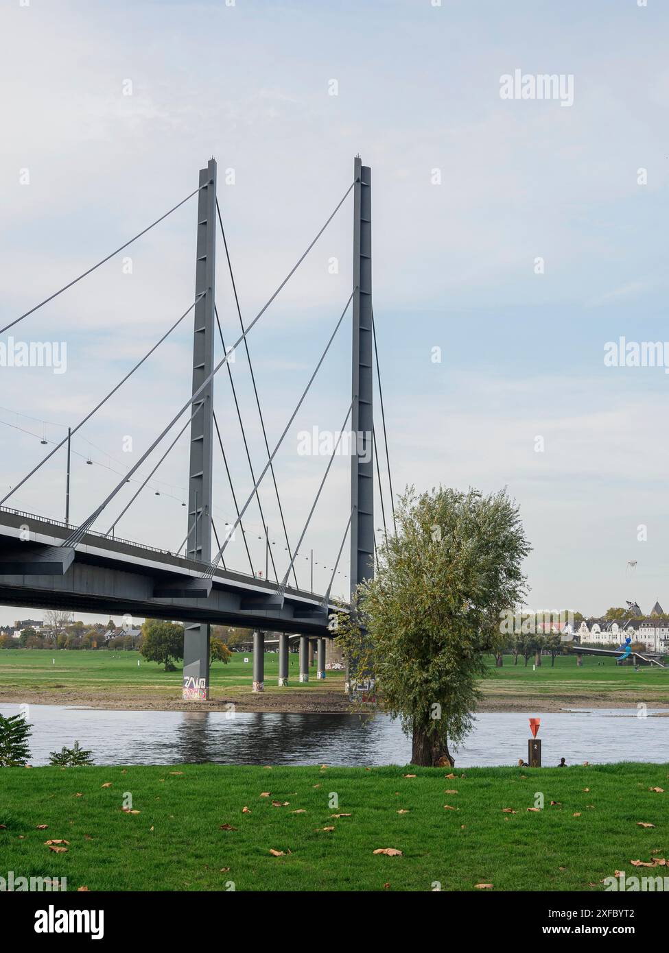 Modern bridge over a river, surrounded by greenery and sky, Duesseldorf ...