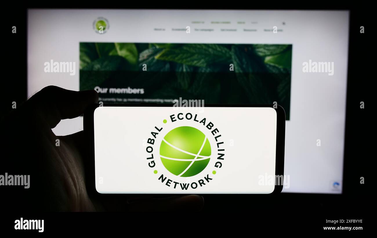 Person holding cellphone with logo of organisation Global Ecolabelling ...
