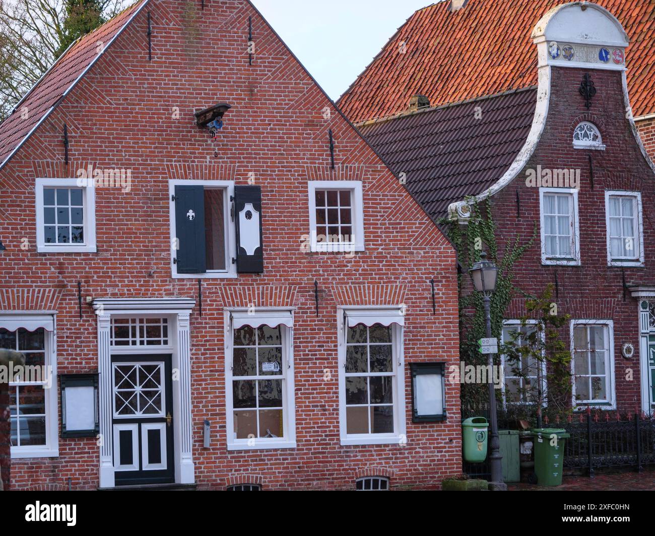 Traditional brick houses with white windows and doors, showing the ...
