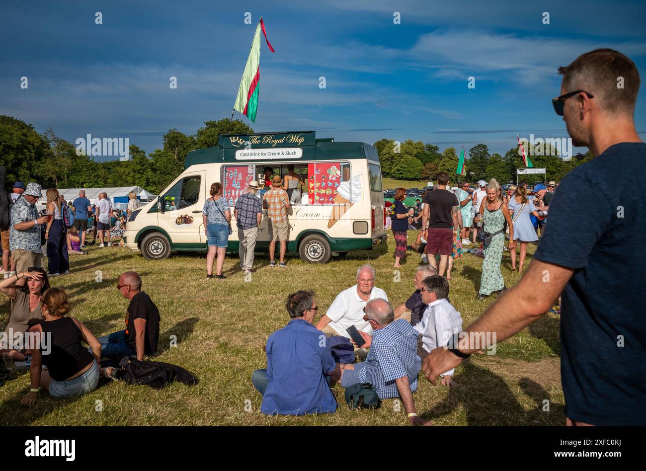 Guildford / UK - Jun 29 2024: Festival goers wait at an ice cream van ...