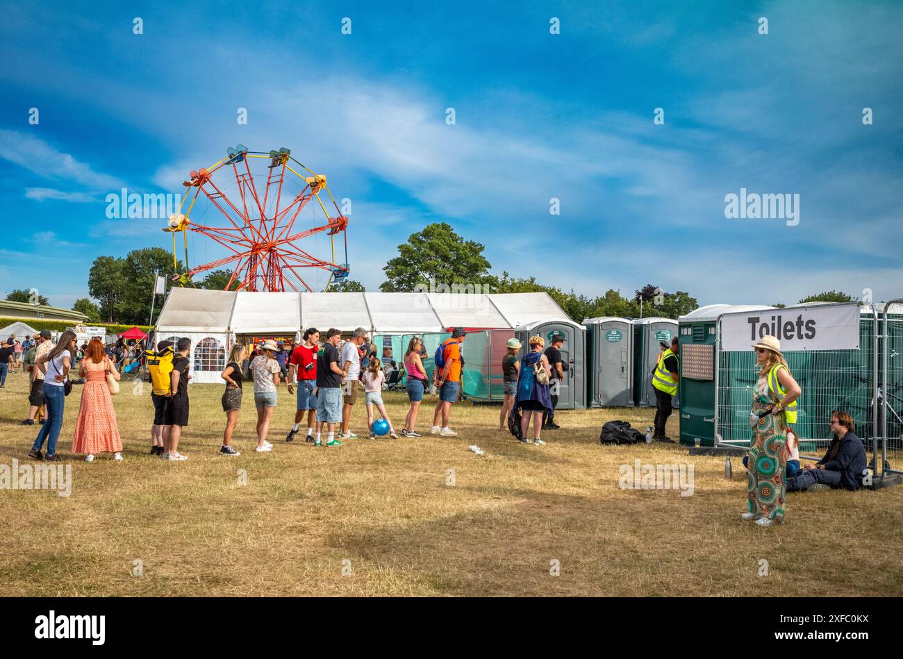 Guildford / UK - Jun 29 2024: People queue for the toilets near a ...