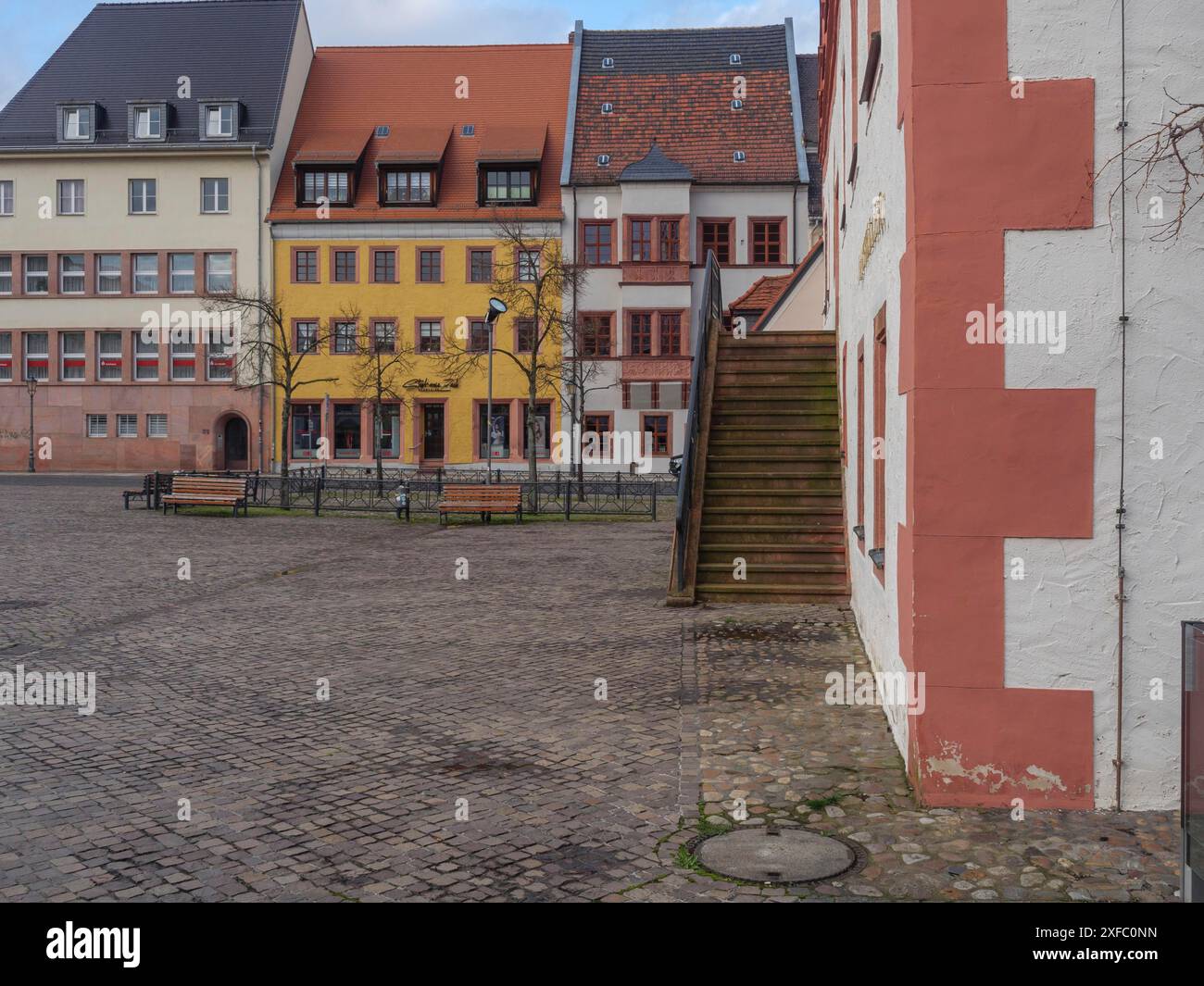 An empty town square with colourful historic buildings and stairs on ...