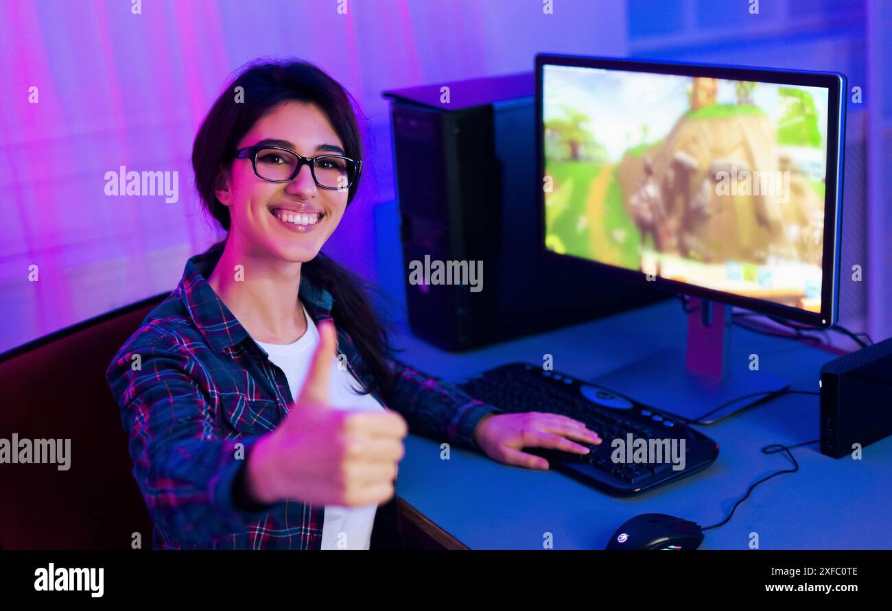 Happy Gamer Woman Giving Thumbs Up While Playing PC Game Stock Photo ...