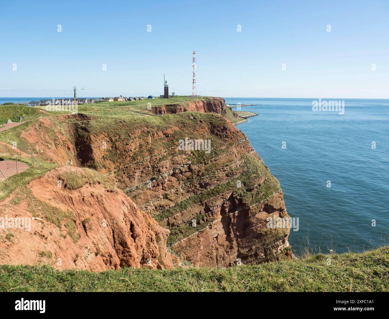 Steep cliffs on the coast with lighthouse and blue sky, helgoland ...