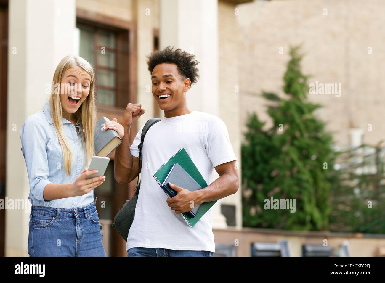 Excellent marks. Surprised students checking exam results Stock Photo ...