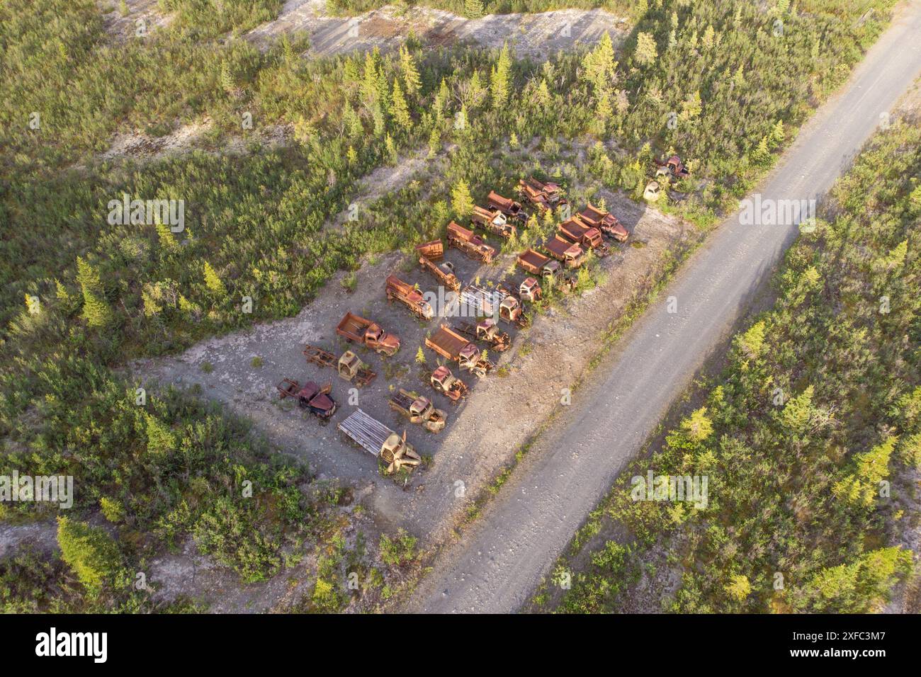 Array of vintage, rusty Ford trucks dumped along the side of the North ...
